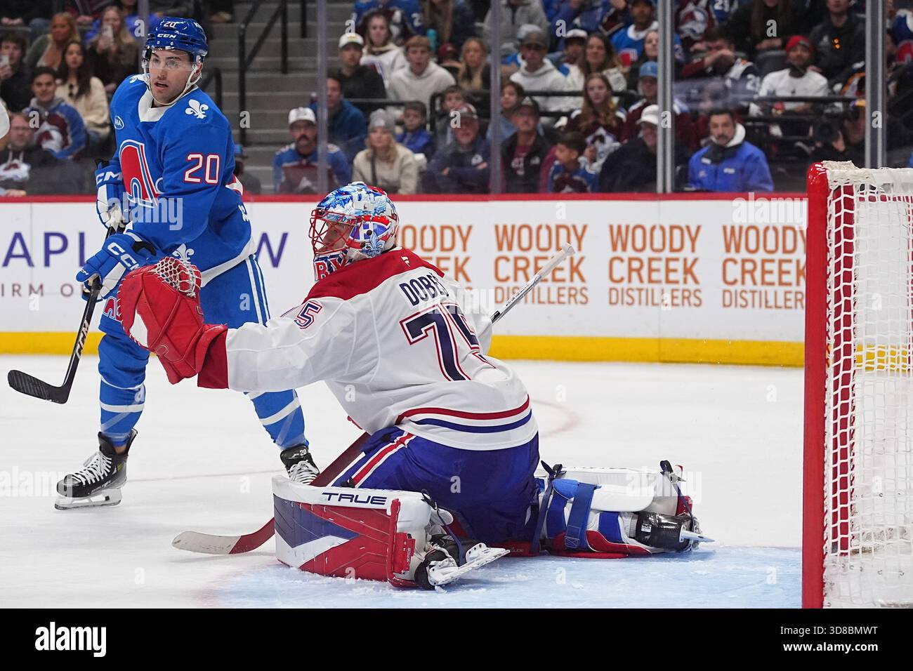 Montreal Canadiens goaltender Jakub Dobes, front, makes a glove save of ...