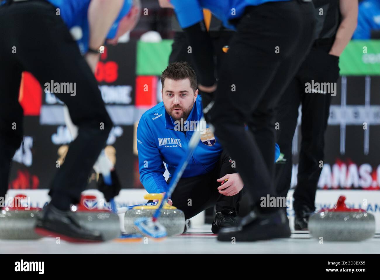 Team Dunstone skip Matt Dunstone watches sweepers from in the house ...