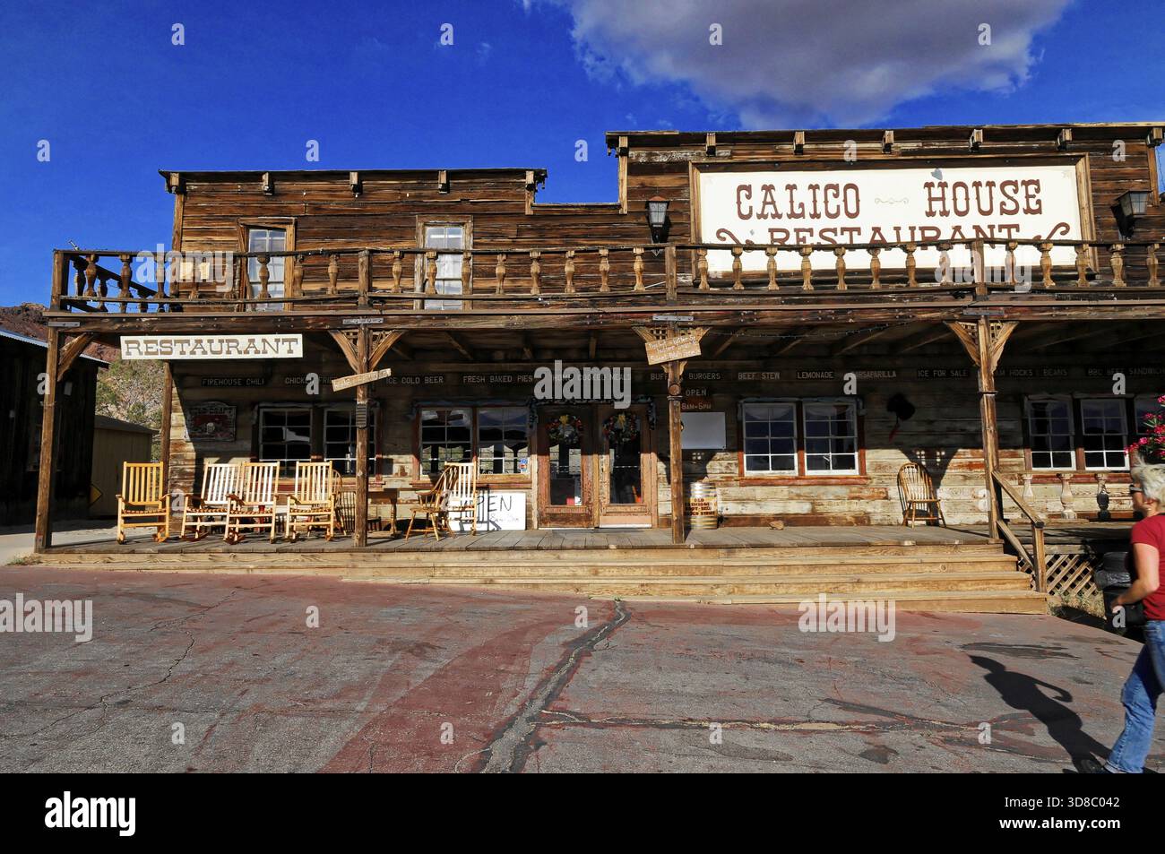 Historic Wild West style wooden restaurant under a clear blue sky, on ...