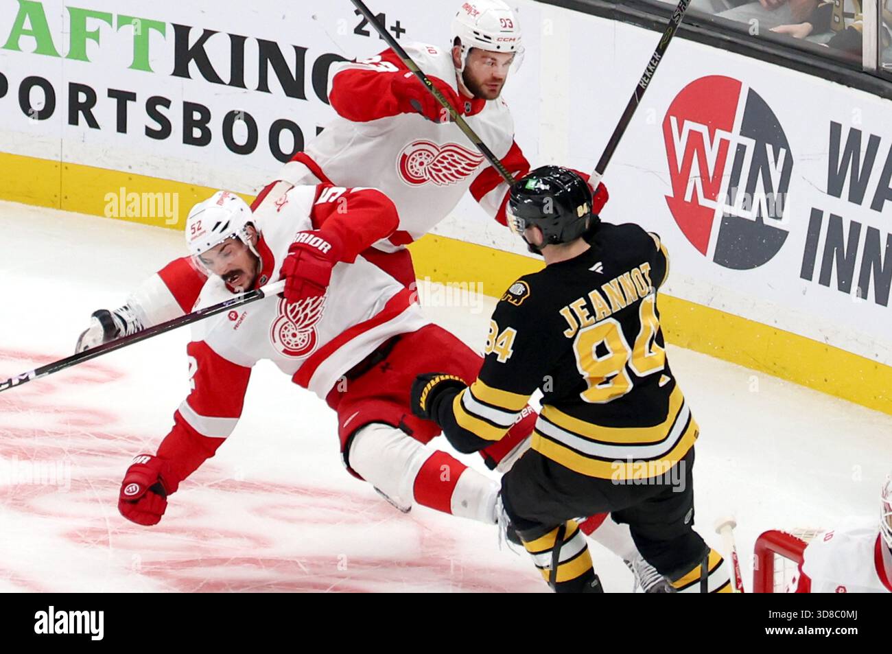 Detroit Red Wings defenseman Travis Hamonic (52) falls to the ice ...