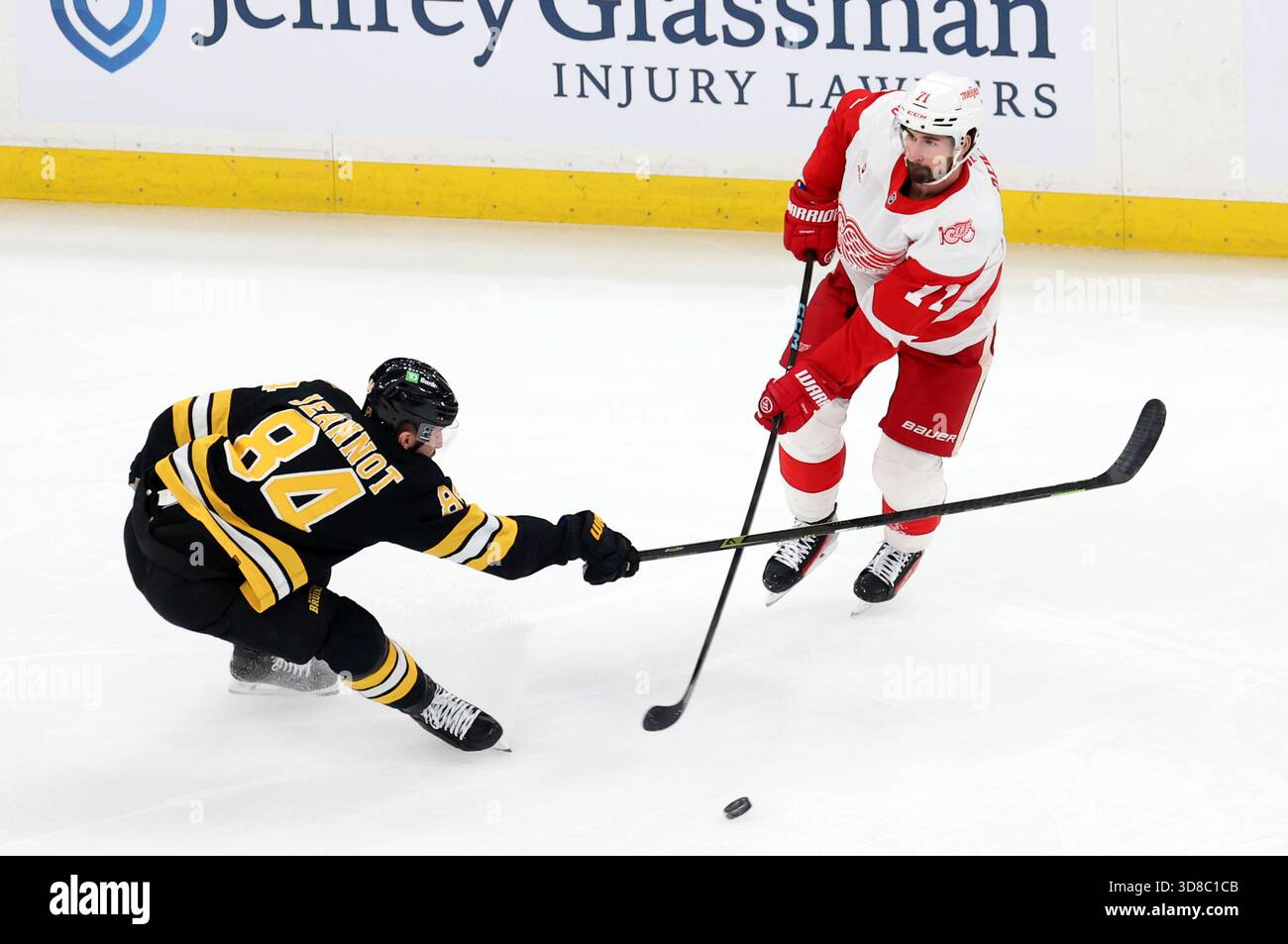 Boston Bruins forward Tanner Jeannot (84) and Detroit Red Wings center ...