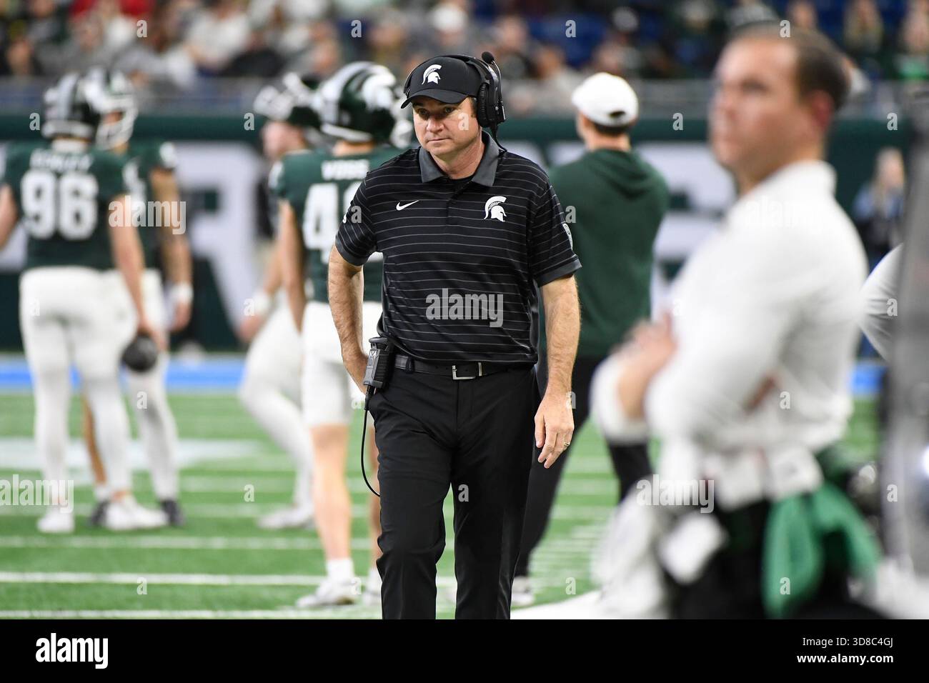 Michigan State head coach Jonathan Smith, center, walks the sideline ...