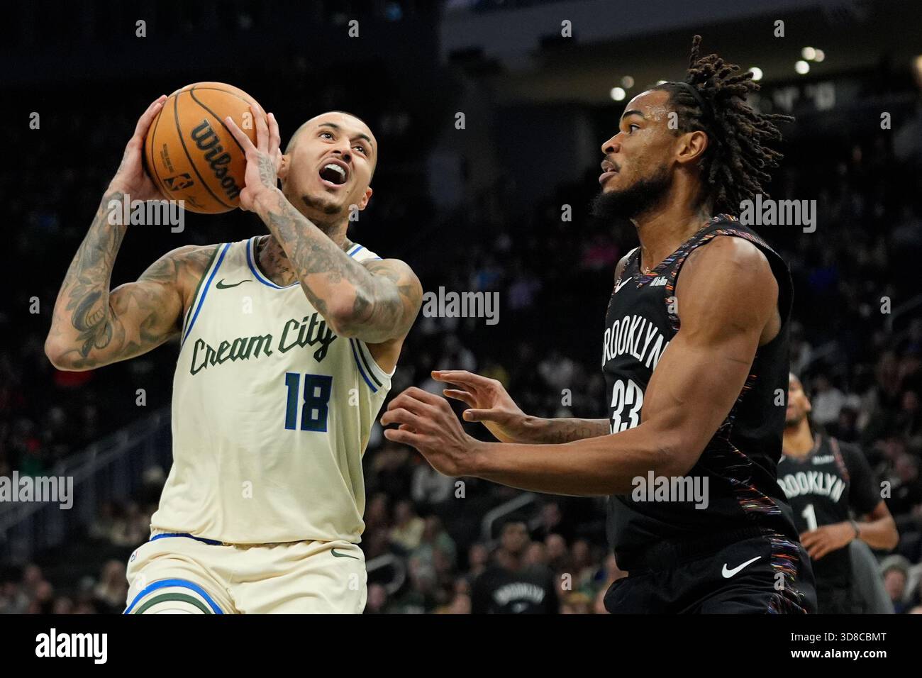 Milwaukee Bucks' Kyle Kuzma (18) drives to the basket against Brooklyn ...