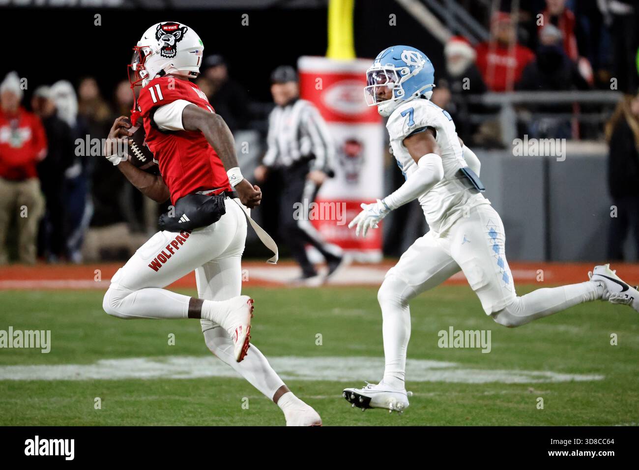 North Carolina State quarterback CJ Bailey (11) runs with the ball away ...