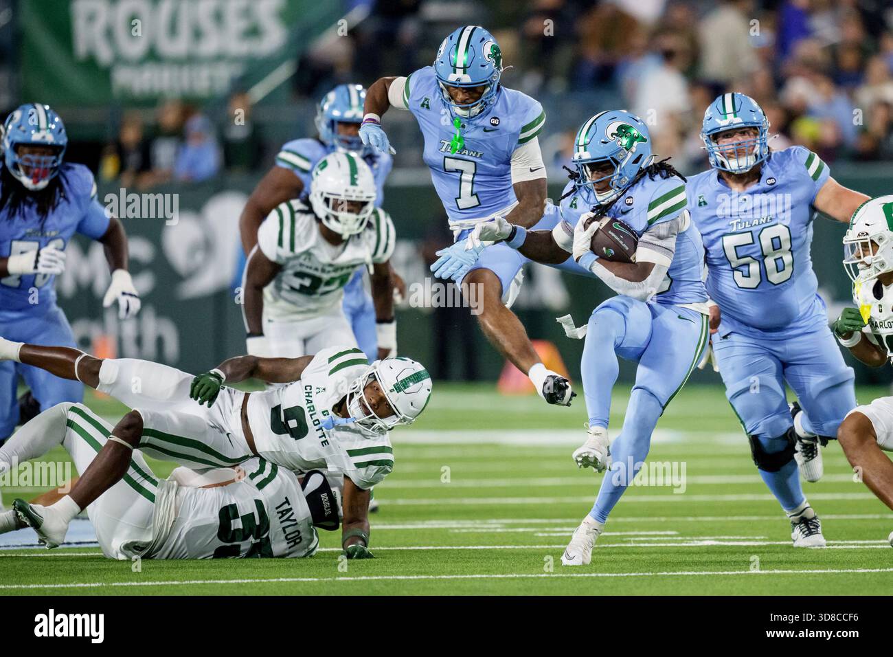 Tulane running back Jamauri McClure (25) runs away from Charlotte ...