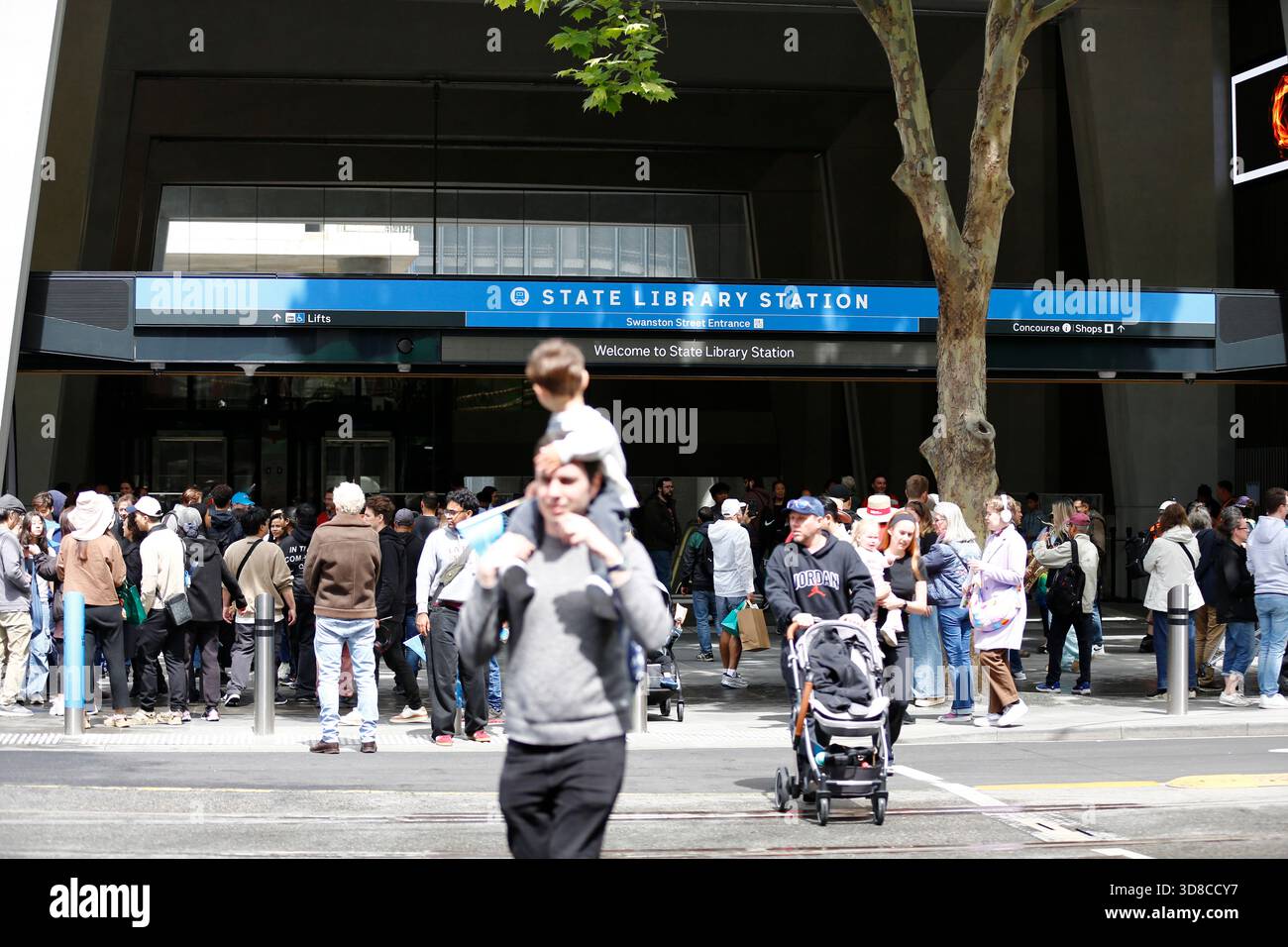 People are seen outside State Library Station. The Metro Tunnel ...