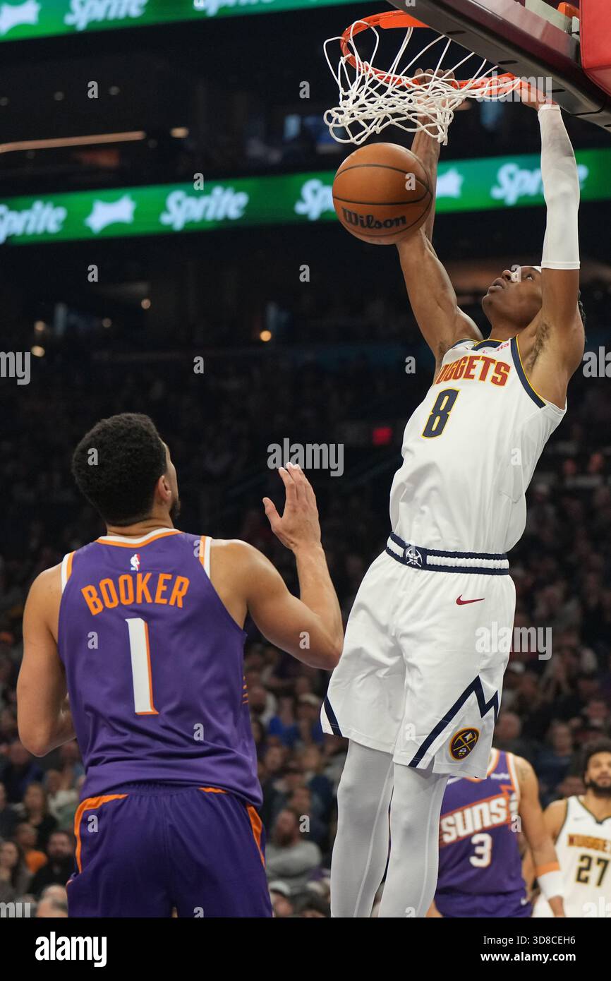 Denver Nuggets guard Peyton Watson (8) dunks over Phoenix Suns guard ...