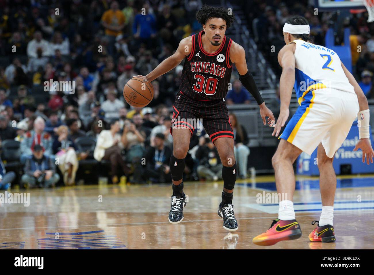 Chicago Bulls guard Tre Jones (30) brings the ball up court in front of ...