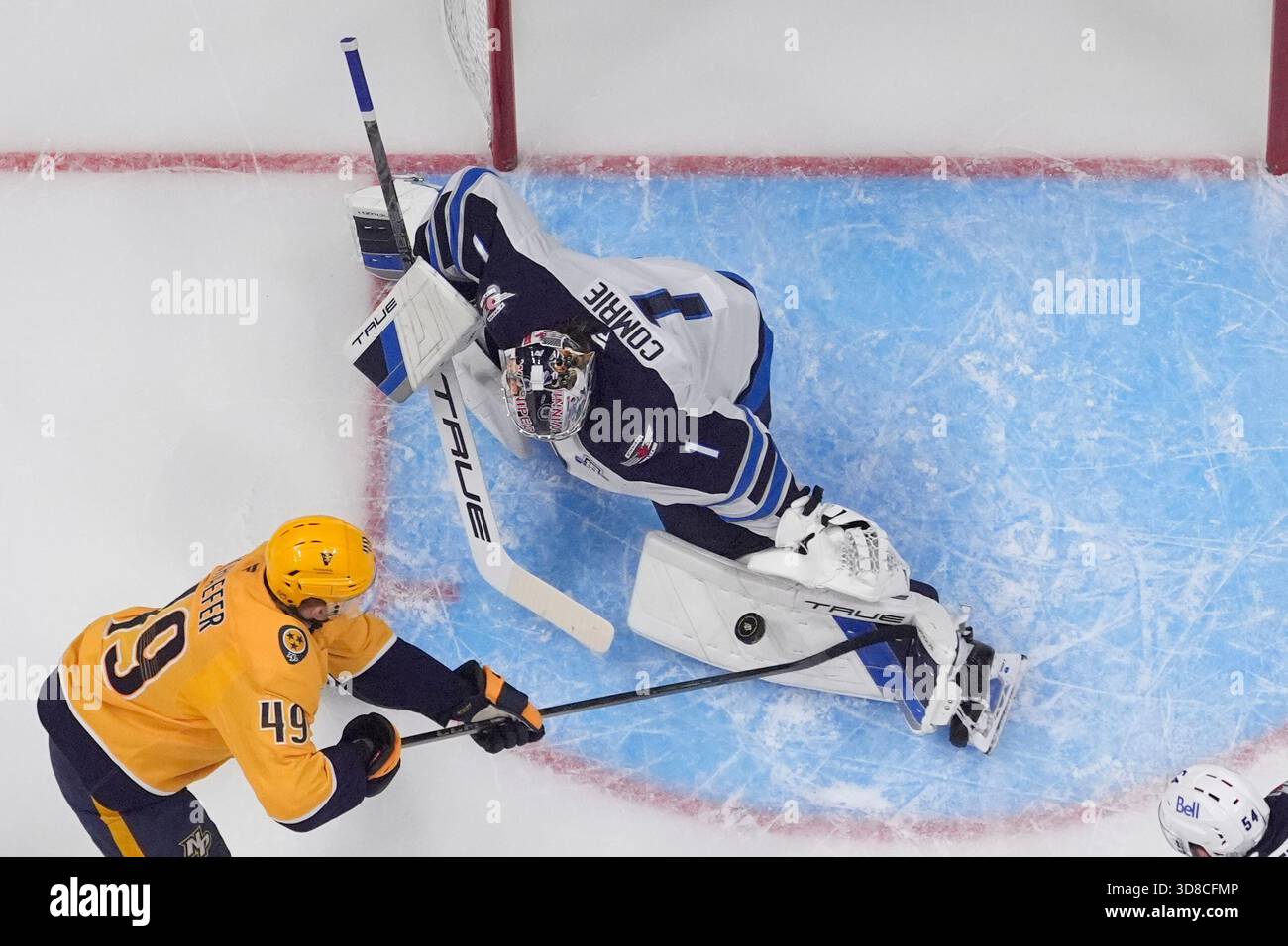 Winnipeg Jets goaltender Eric Comrie (1) blocks a shot on goal by ...