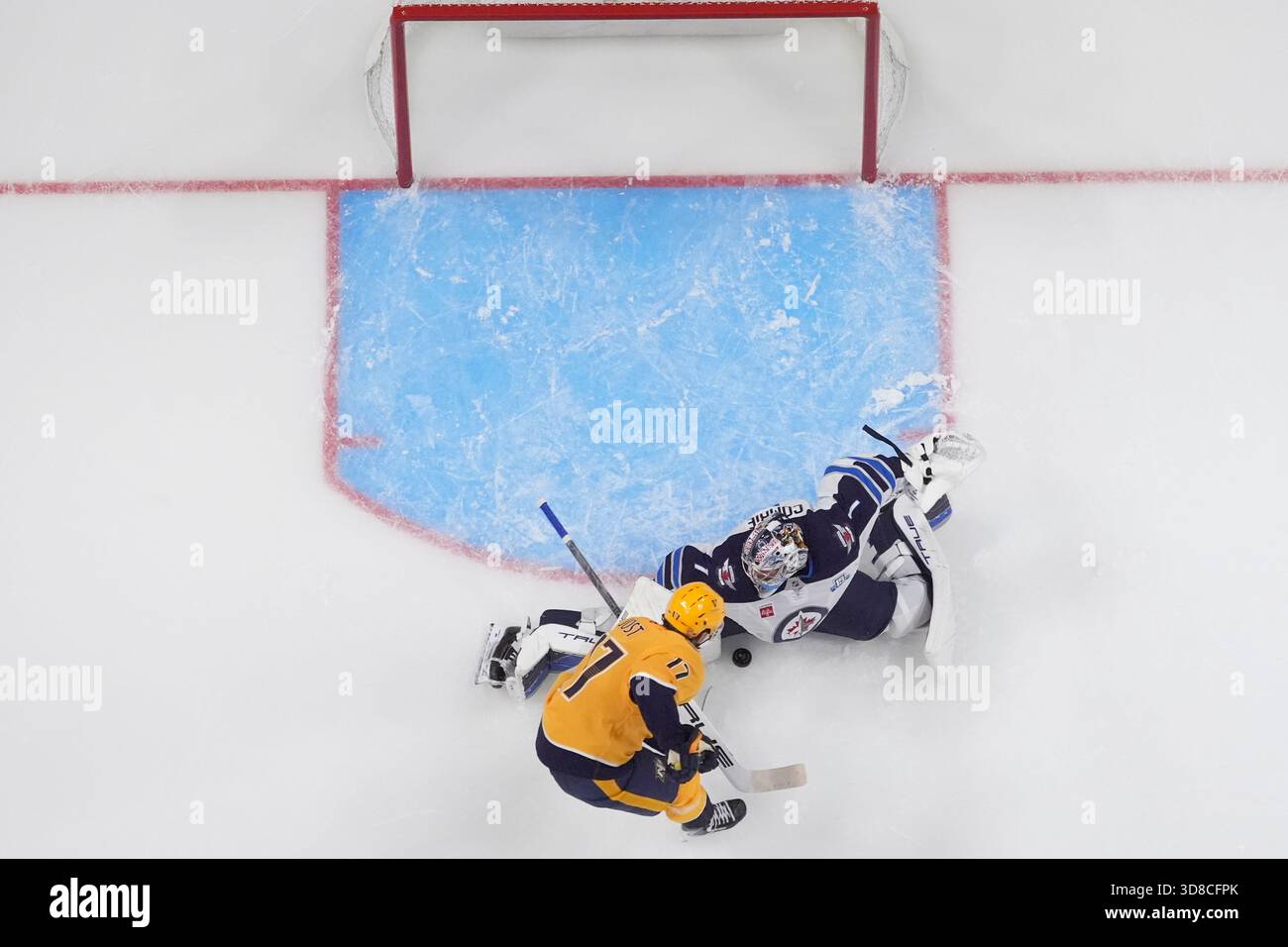 Winnipeg Jets goaltender Eric Comrie (1) defends the goal against ...