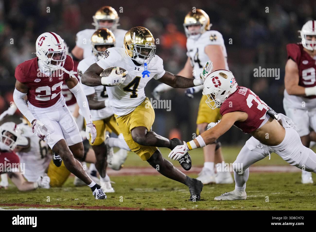 Notre Dame running back Jeremiyah Love (4) stiff arms Stanford safety ...