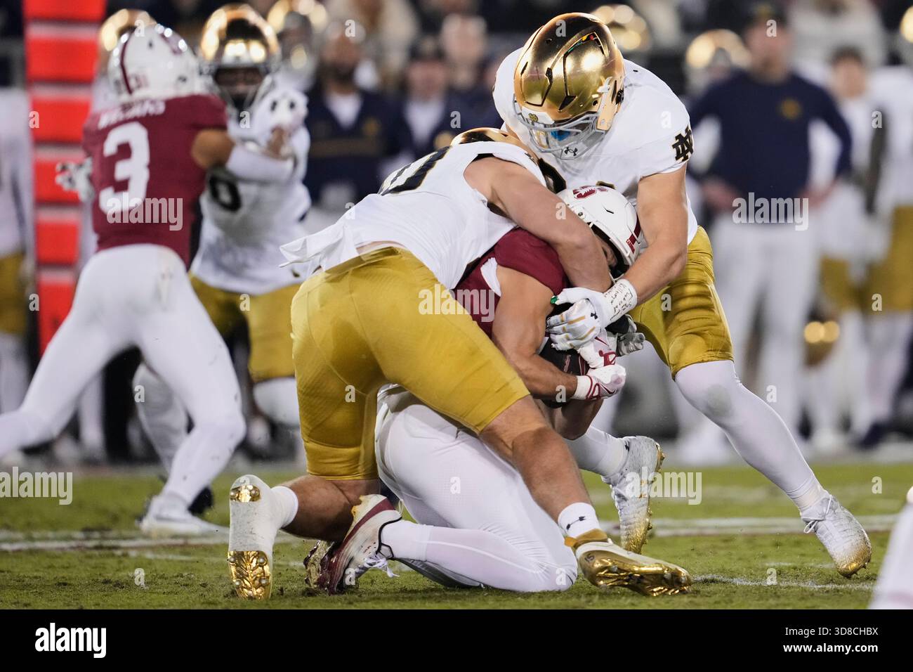 Stanford wide receiver Bryce Farrell, center, is tackled by Notre Dame ...