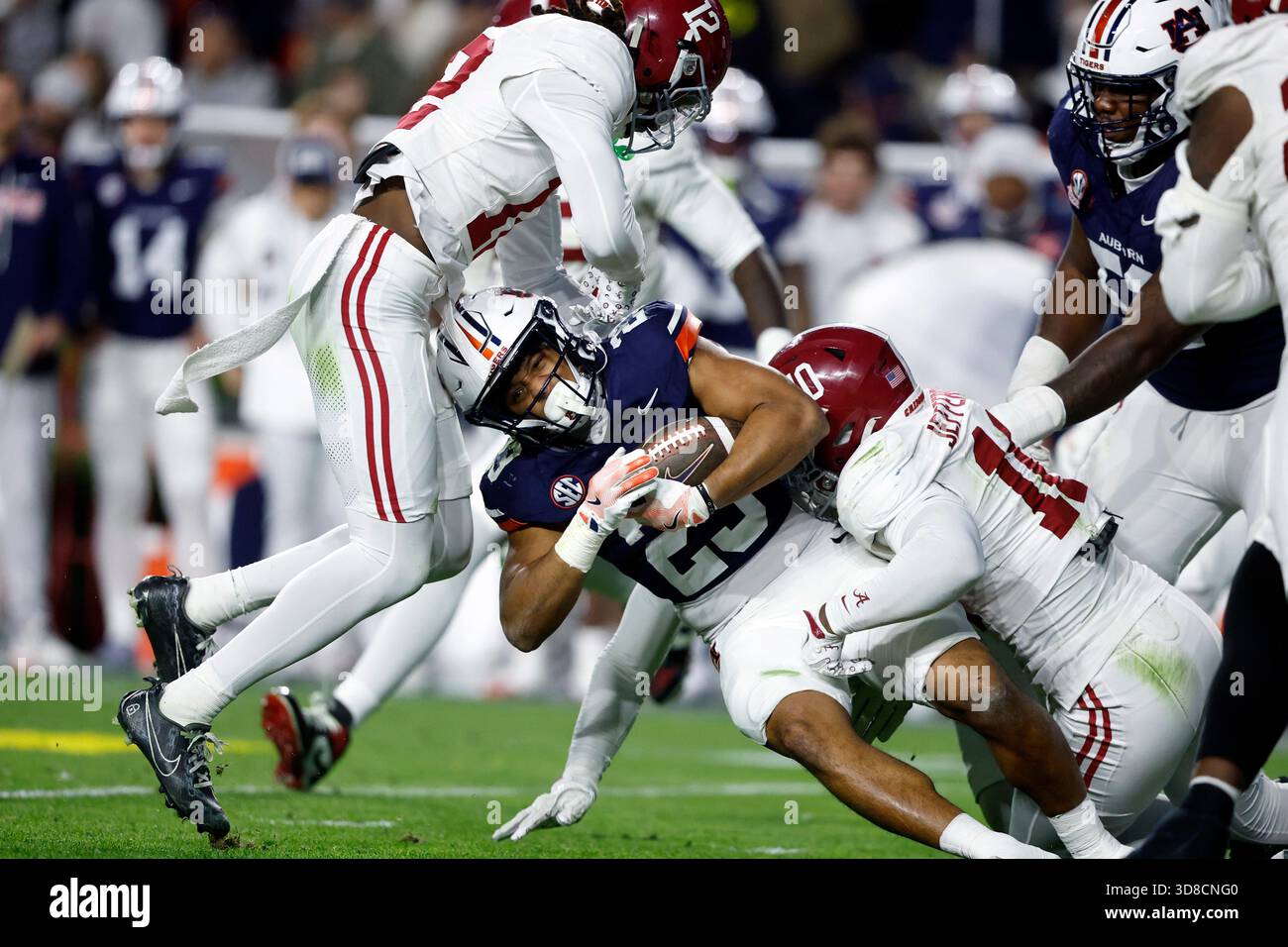 Auburn running back Jeremiah Cobb (23) is tackled by Alabama defensive ...