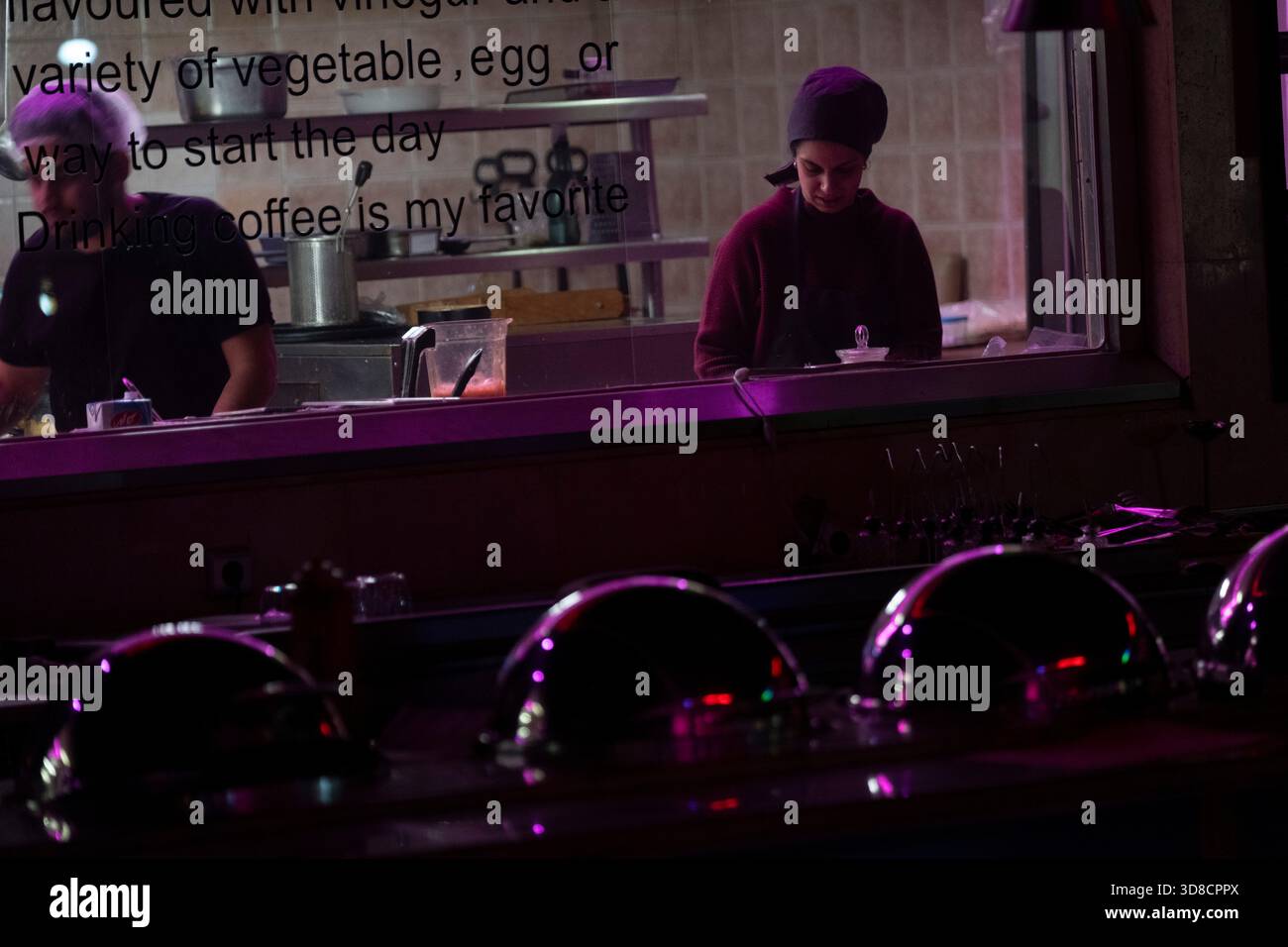 A female Iranian chef works in the kitchen of a luxury cafe-restaurant ...
