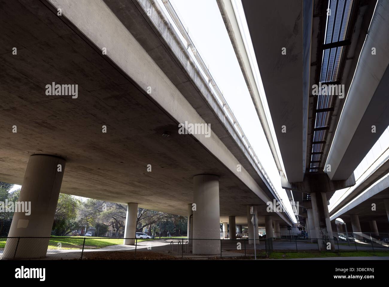 Massive concrete freeway overpasses and elevated tracks create a maze ...