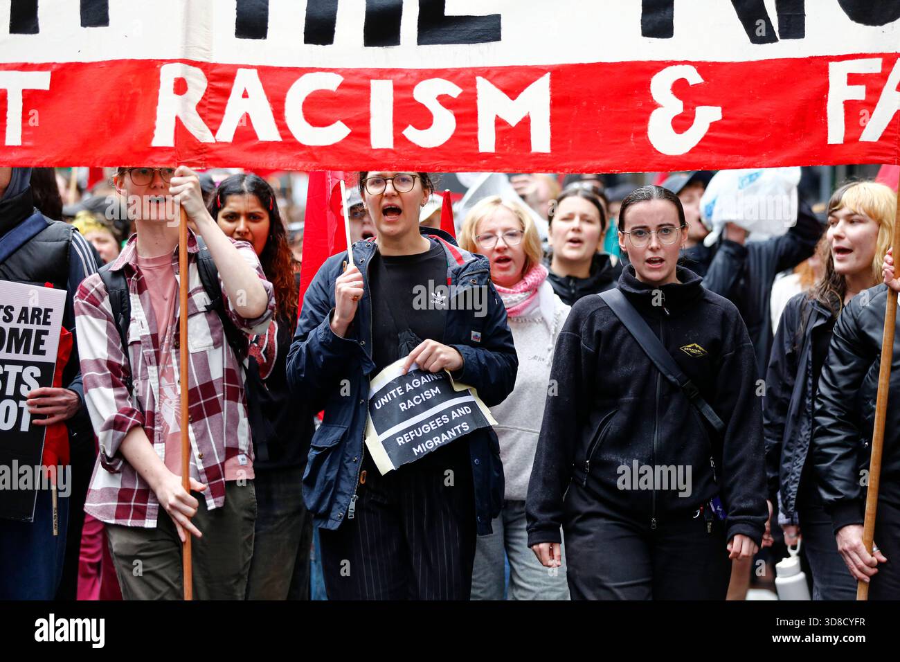 Counter-protesters chant slogans during the rally. An anti-immigration ...
