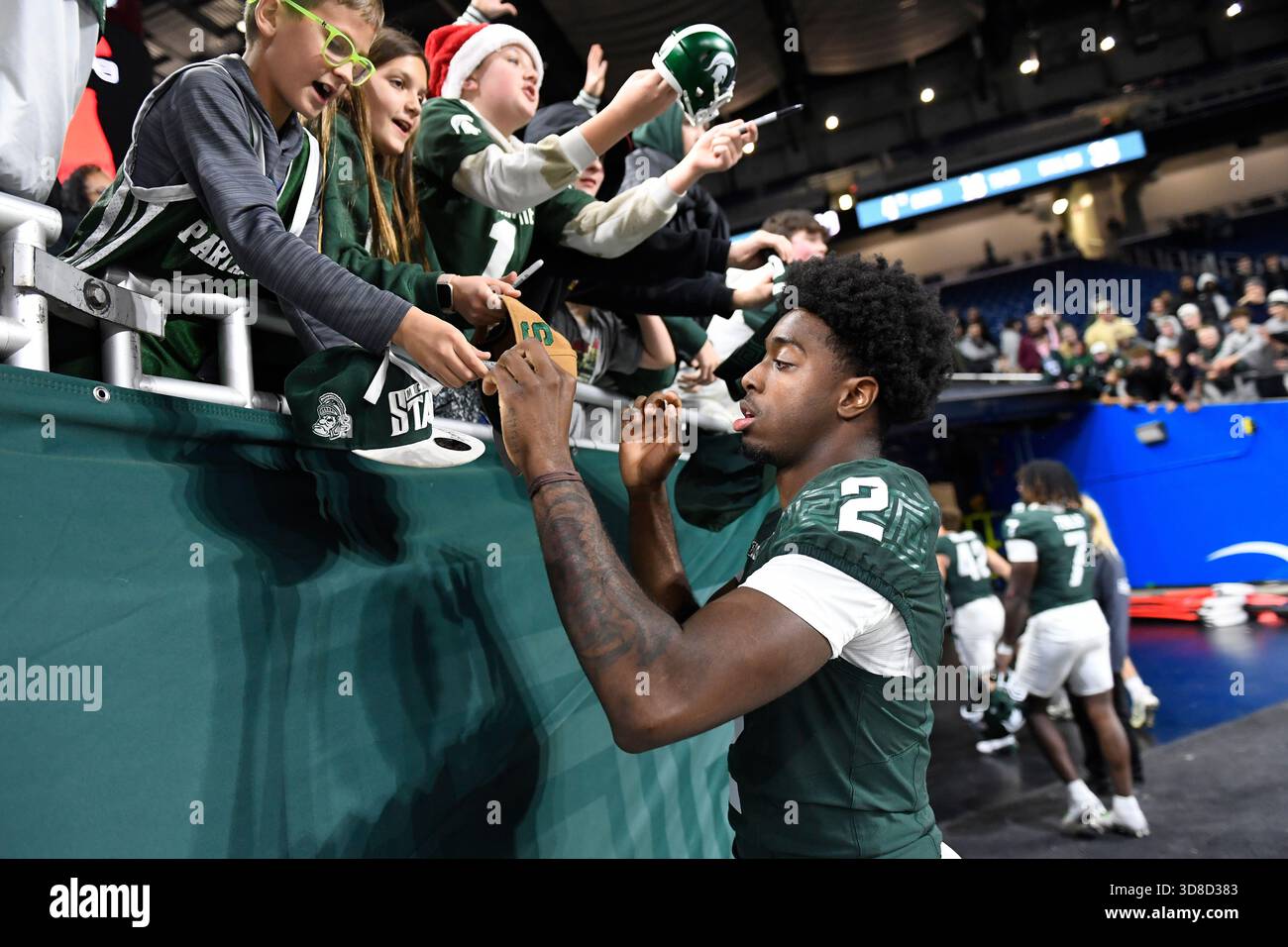 Michigan State quarterback Aidan Chiles (2) signs an autograph for a ...