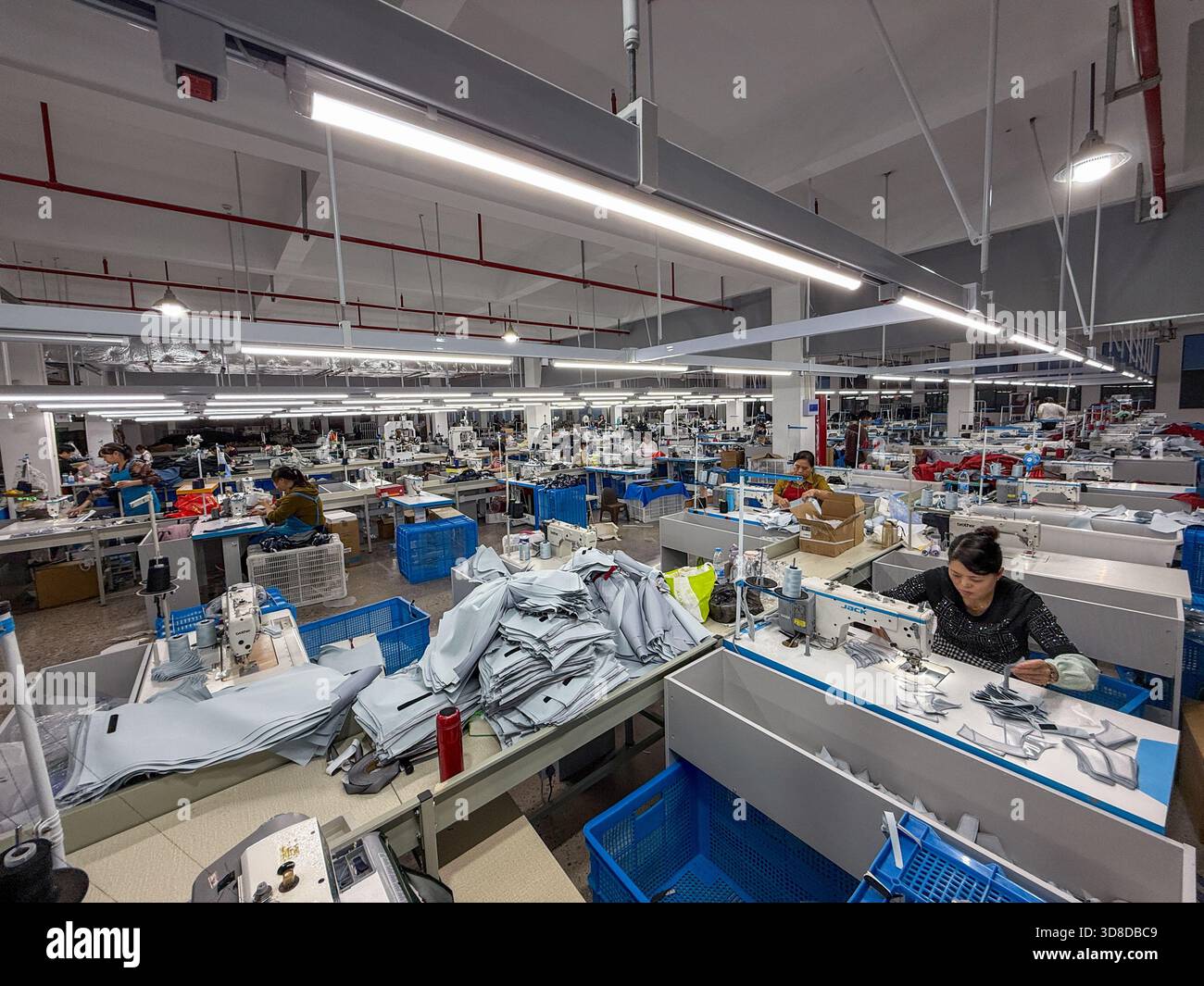 People work at an apparel factory making waterproof jackets in Sanmen ...