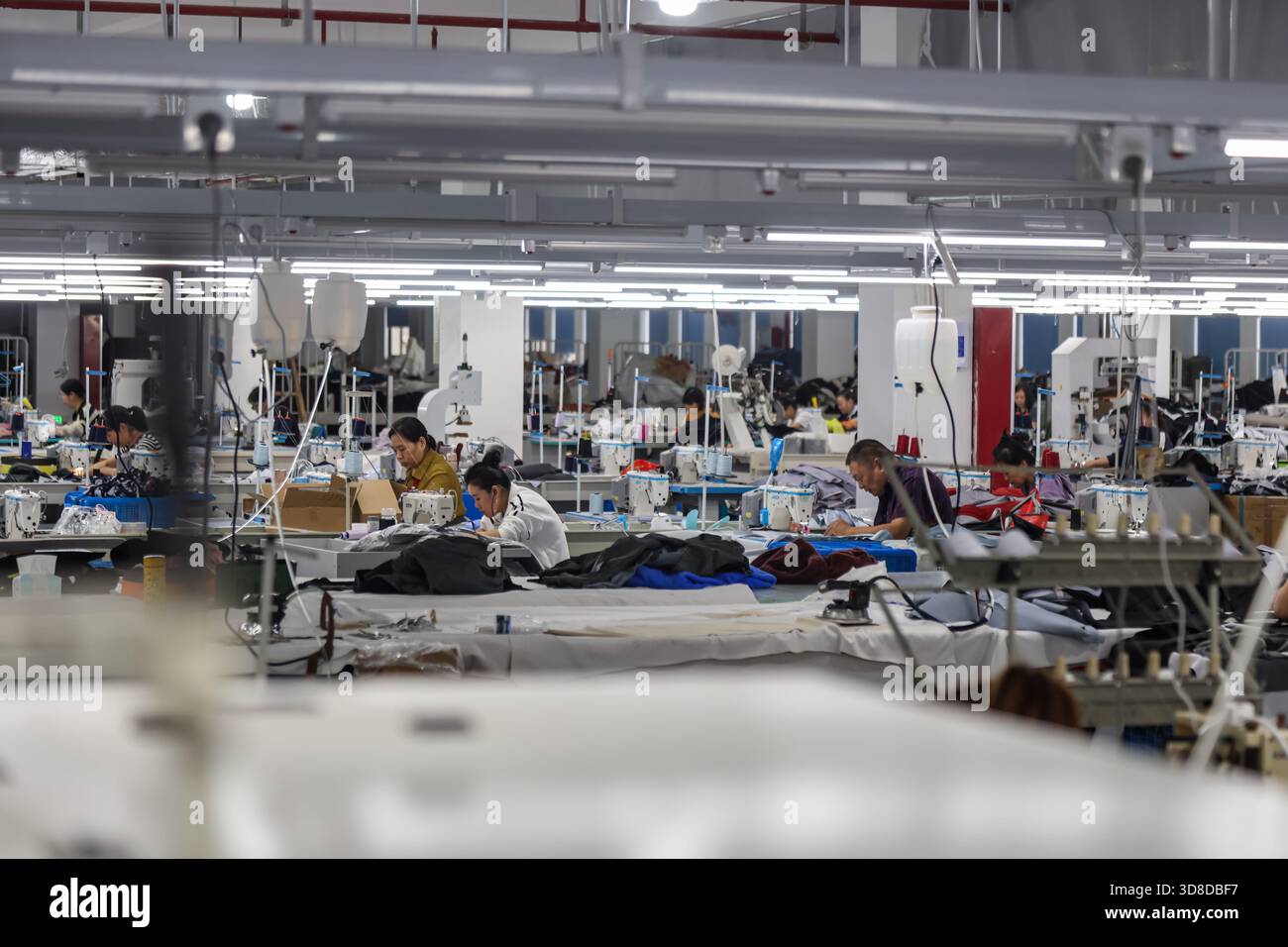 People work at an apparel factory making waterproof jackets in Sanmen ...