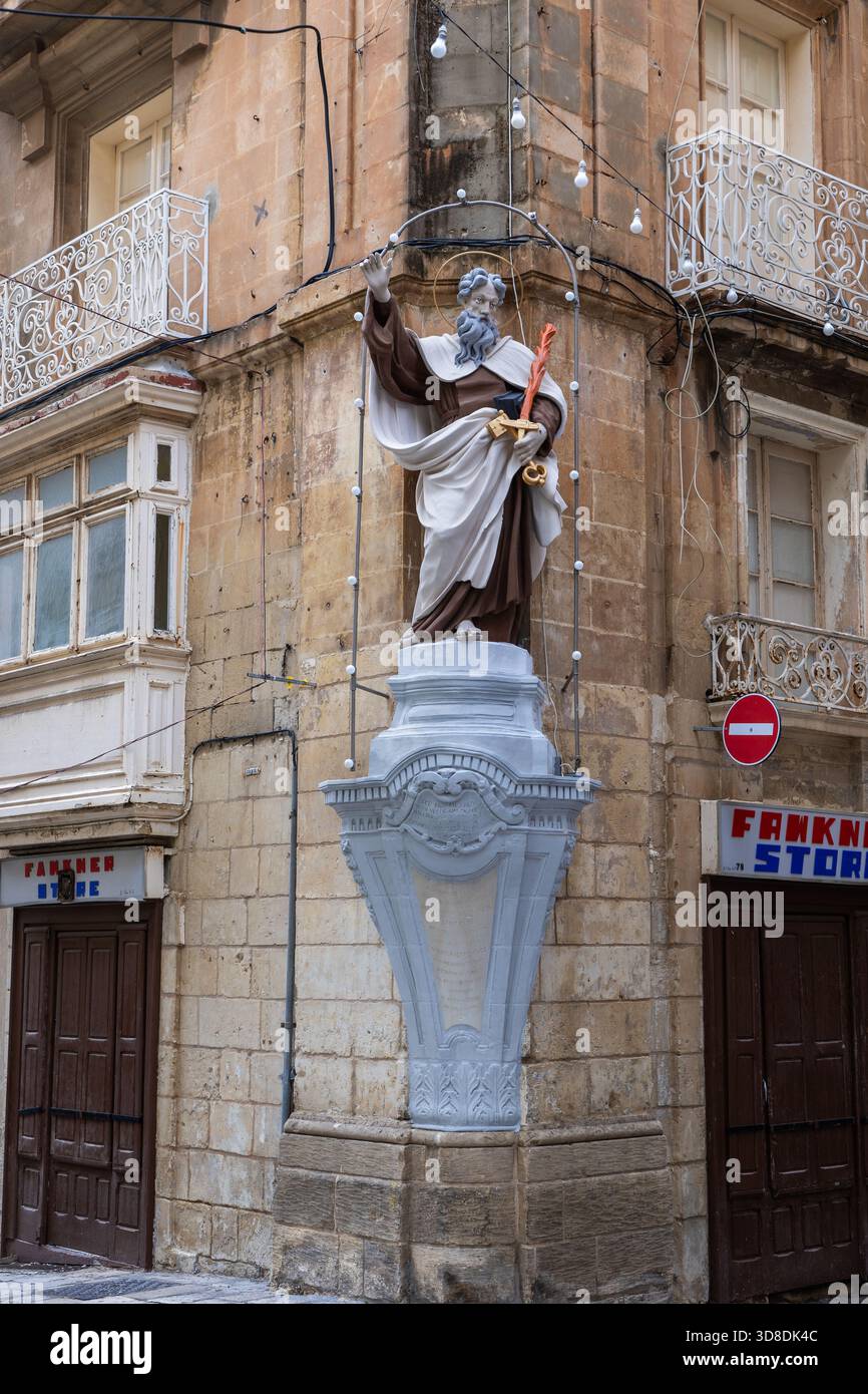 Saint Elias with fiery sword statue on building corner in city of ...