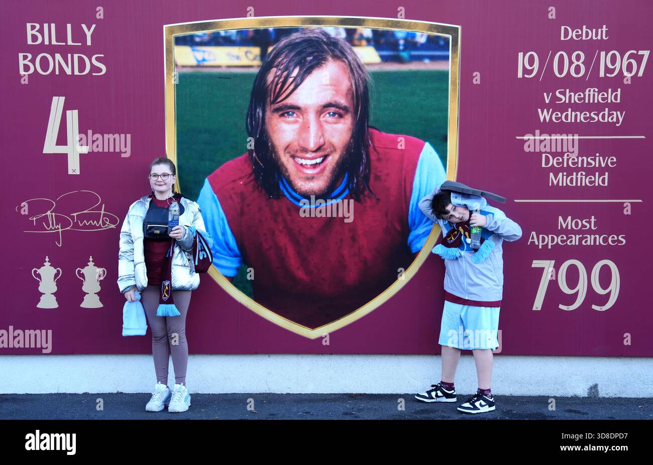 Fans stand by a mural of former West Ham United player and manager ...