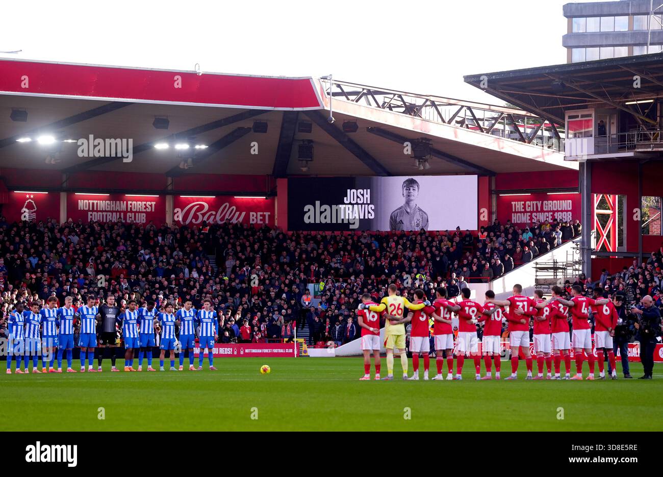 Nottingham Forest and Brighton and Hove Albion players stand for a ...