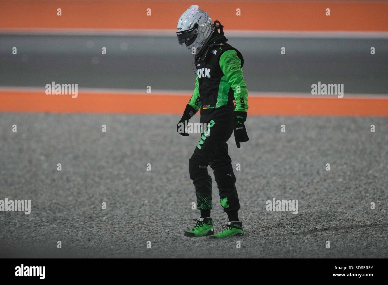 Kick Sauber driver Nico Hulkenberg of Germany walks back to his pits ...