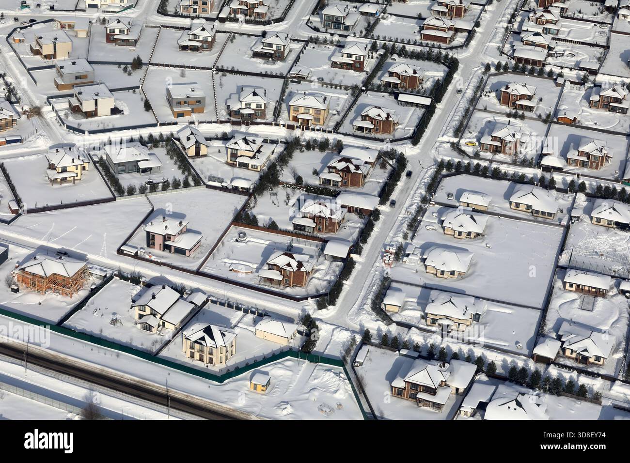 Aerial view of suburban neighborhood with many modern houses covered in ...