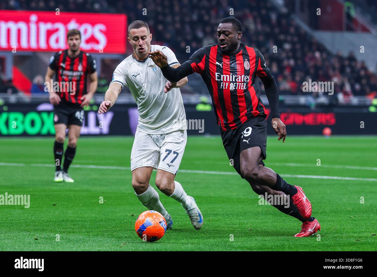 Youssouf Fofana of AC Milan competes for the ball with Adam Marusic of ...