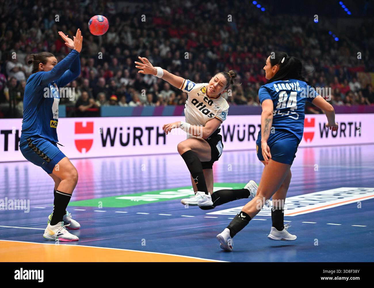 Germany's Emily Vogel, center, in action against Serbia's Sara Garovic ...