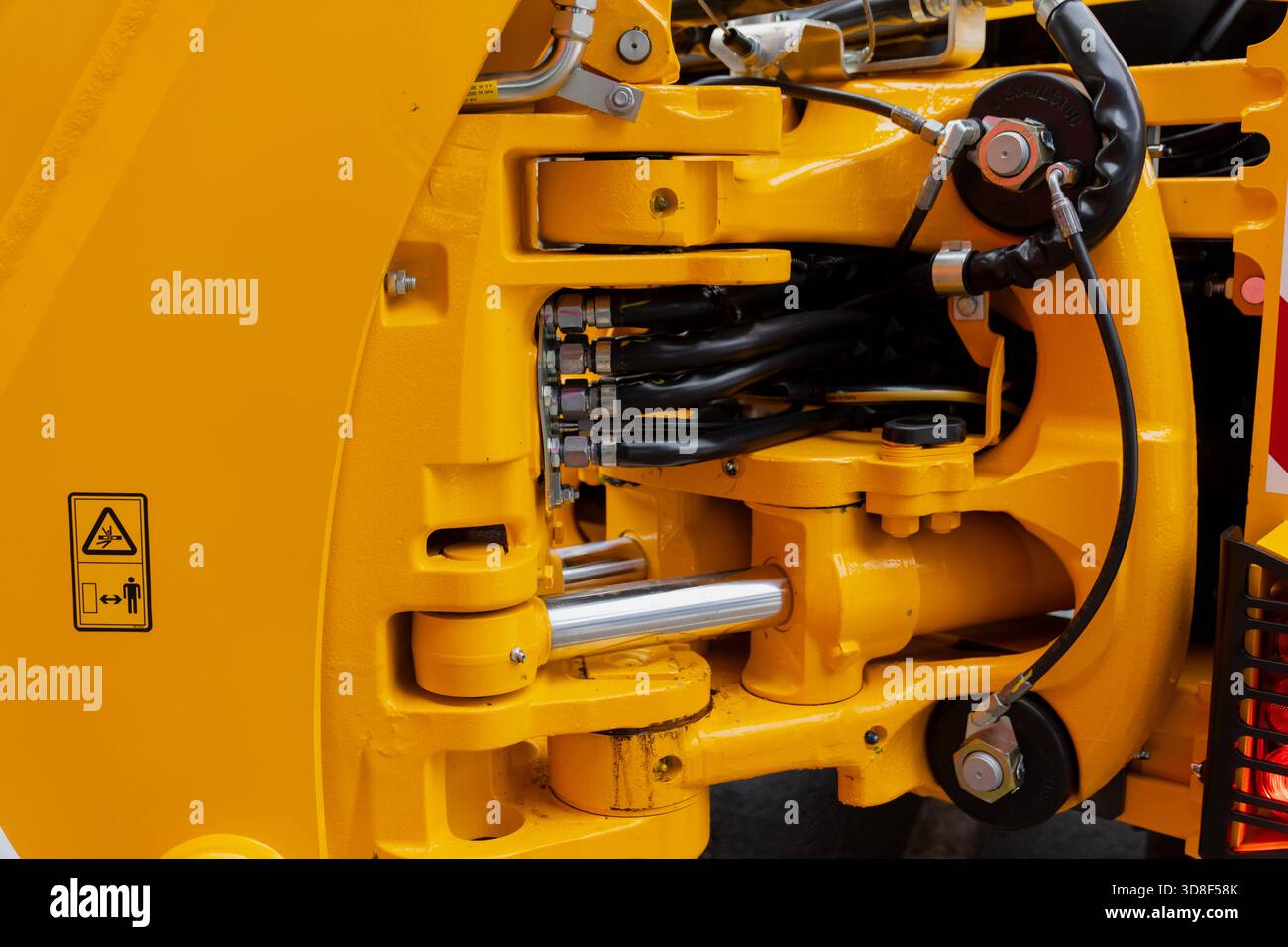 Perspective of interconnected hydraulic hoses, polished cylinders, and ...
