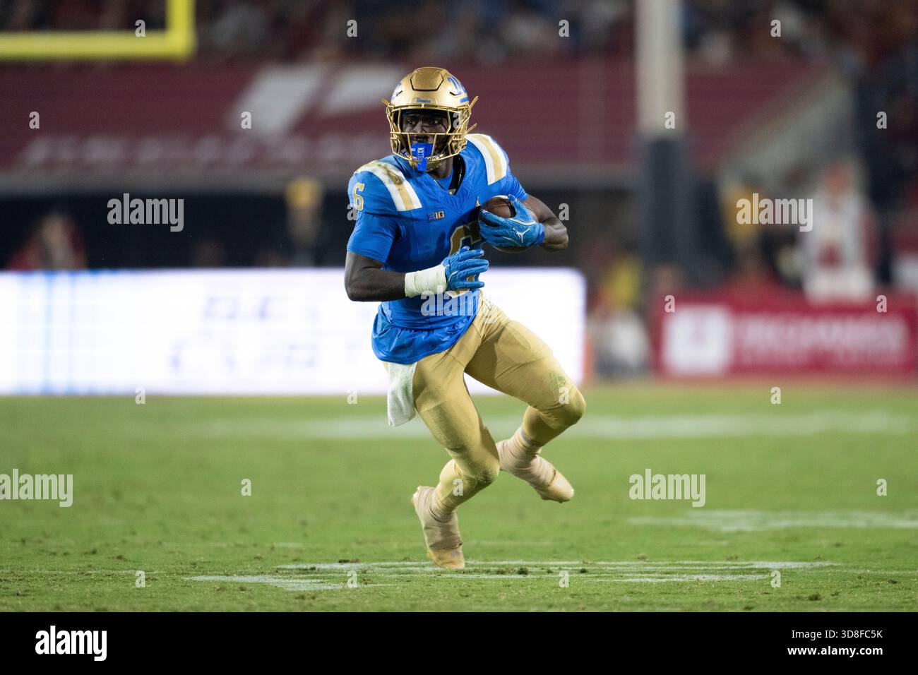 UCLA running back Anthony Woods (6) runs with the ball during an NCAA ...