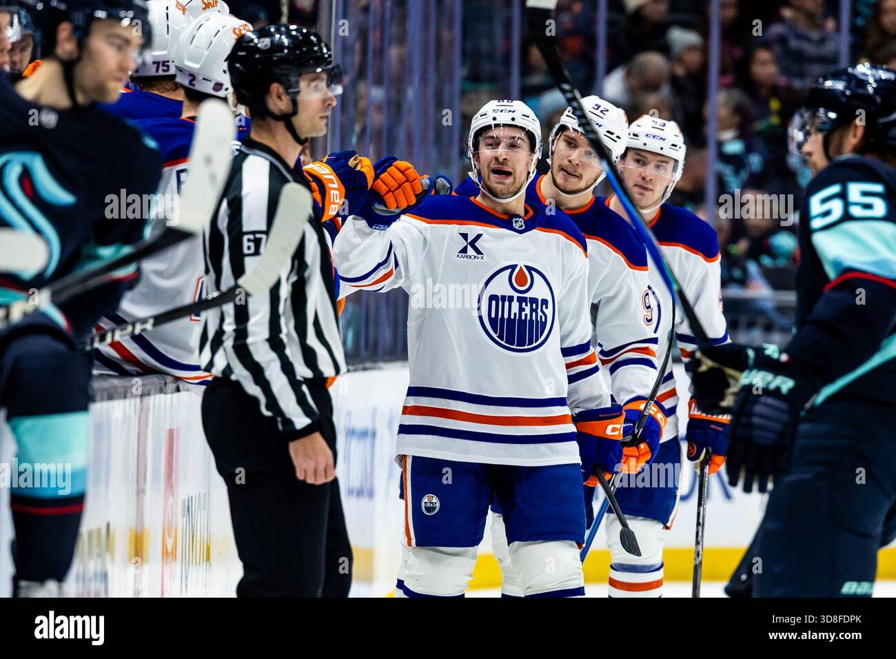 Edmonton Oilers left wing Andrew Mangiapane high-fives the bench after ...