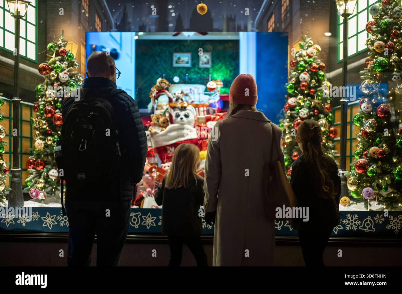 A family look at the Hamleys Christmas Window Display on Regent Street ...