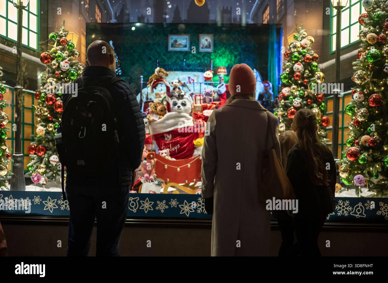 A family look at the Hamleys Christmas Window Display on Regent Street ...