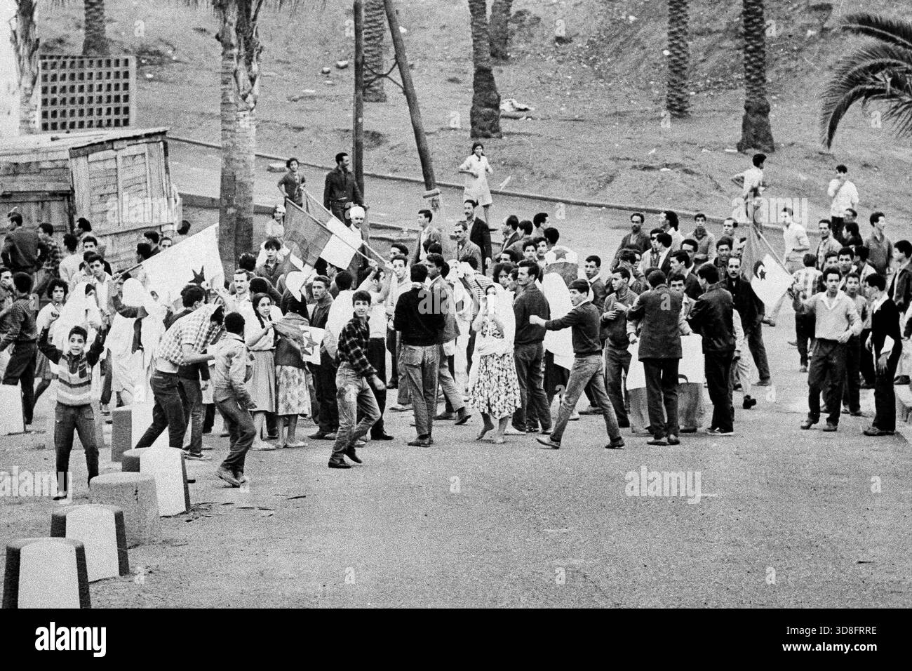 FILE - Young Muslims gather around the green and white FLN rebel flags ...