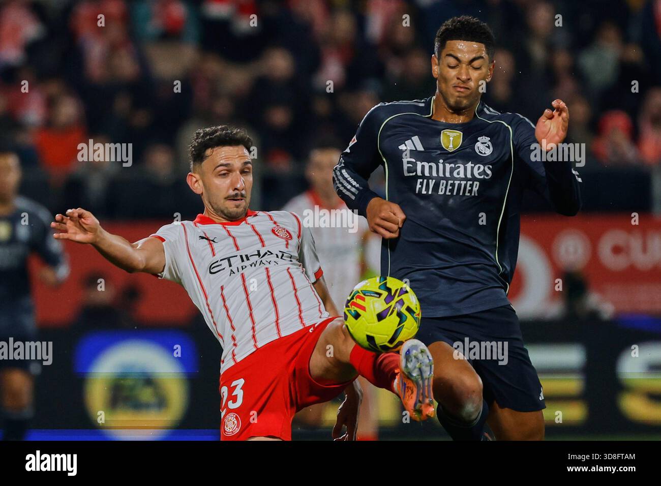 Real Madrid's Jude Bellingham, right, fights for the ball with Girona's ...
