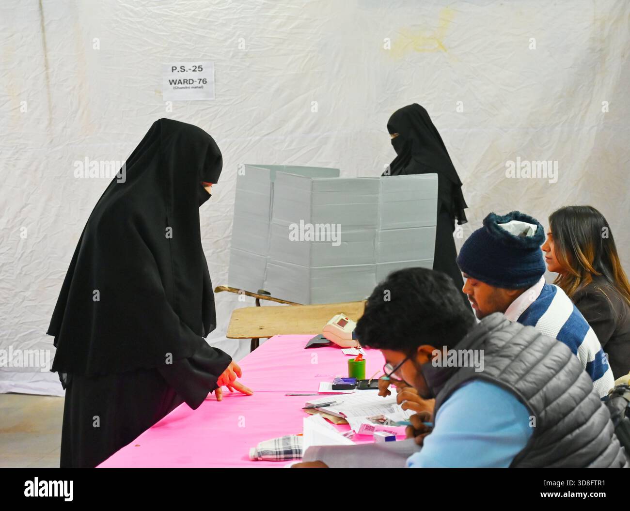 NEW DELHI, INDIA - NOVEMBER 30: Voters cast their votes at a polling ...