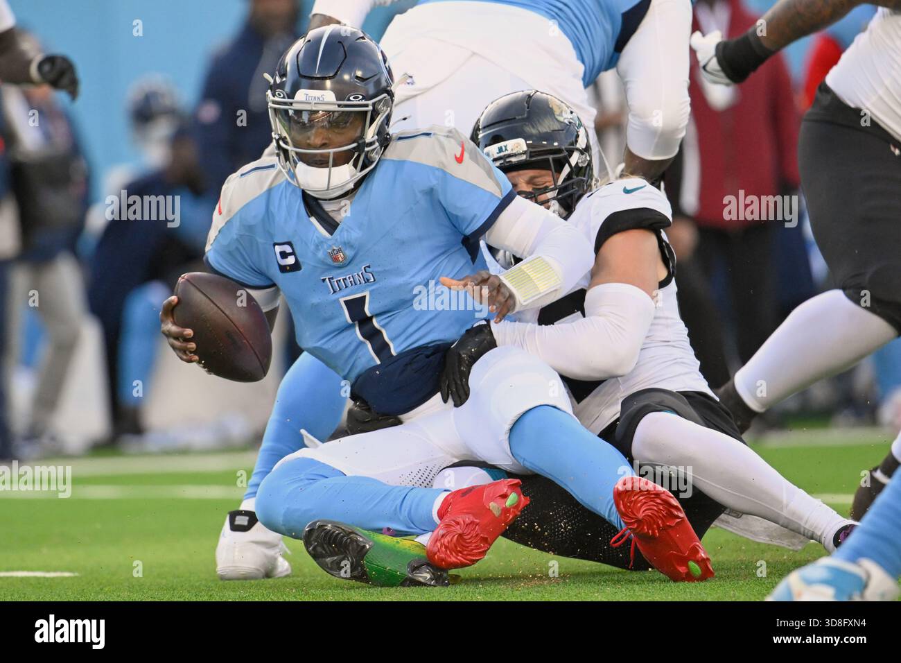 Tennessee Titans quarterback Cam Ward (1) is sacked by Jacksonville ...
