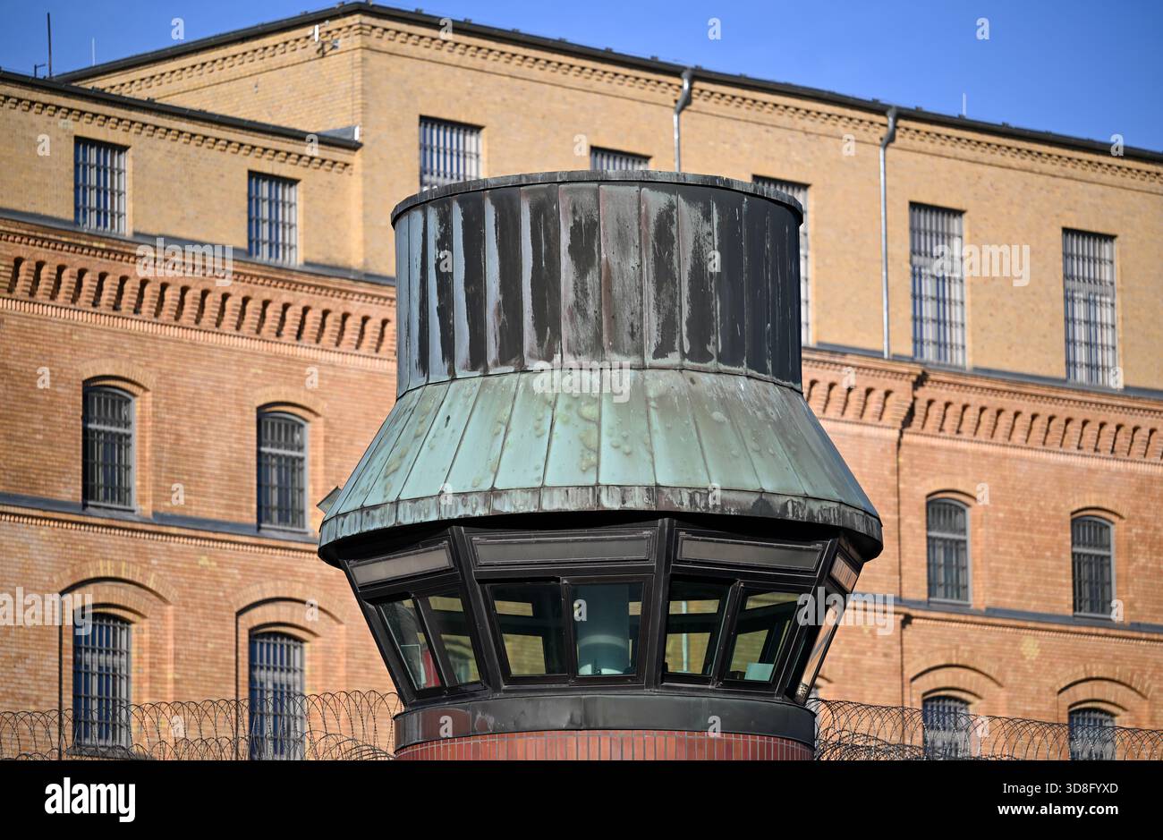 27 November 2025, Berlin: The fence and an observation tower at Moabit ...