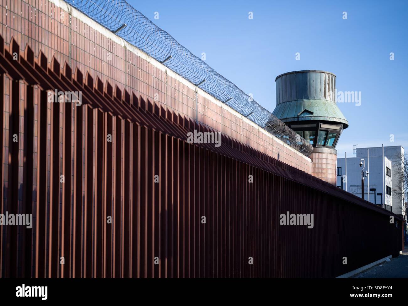 27 November 2025, Berlin: The fence and an observation tower at Moabit ...