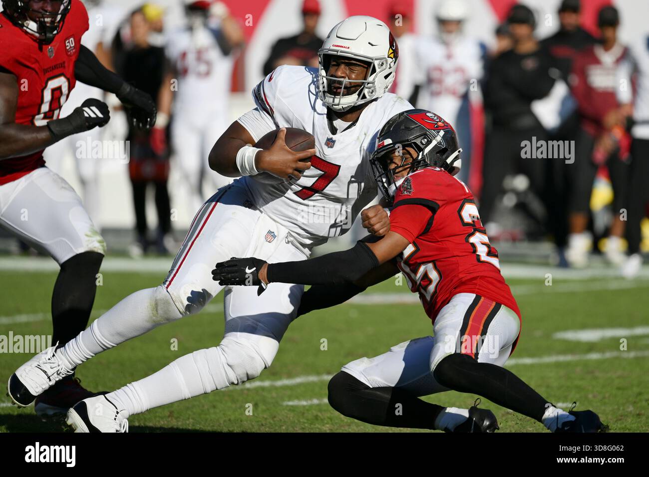 Arizona Cardinals quarterback Jacoby Brissett, left, is tackled by ...