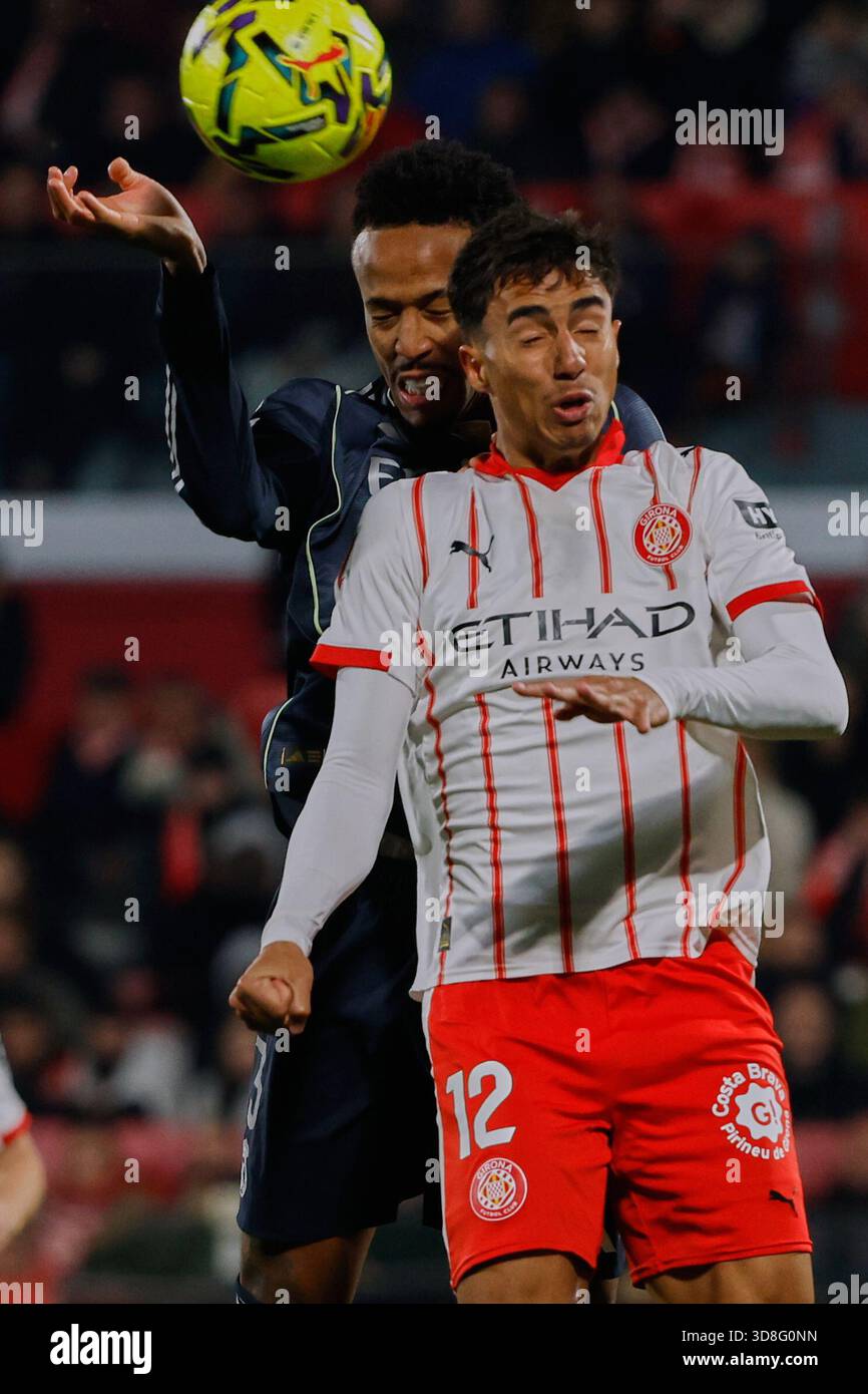 Real Madrid's Eder Militao, left, heads for the ball with Girona's ...