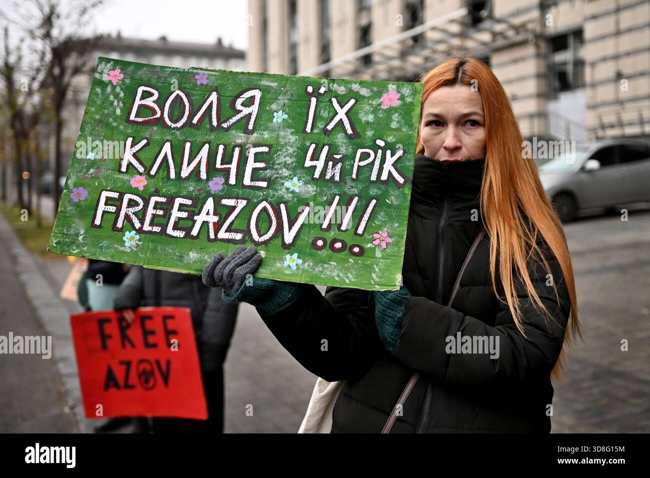 A woman holds a poster reading " Will their nickname is 4th year Free ...