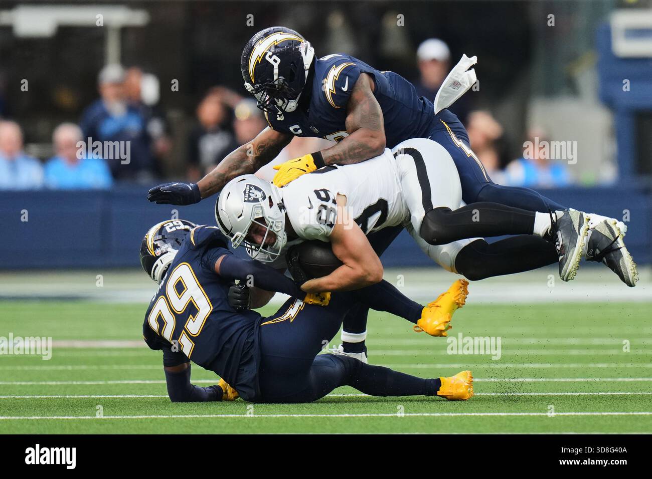 Las Vegas Raiders tight end Brock Bowers (89) is tackled by Los Angeles ...