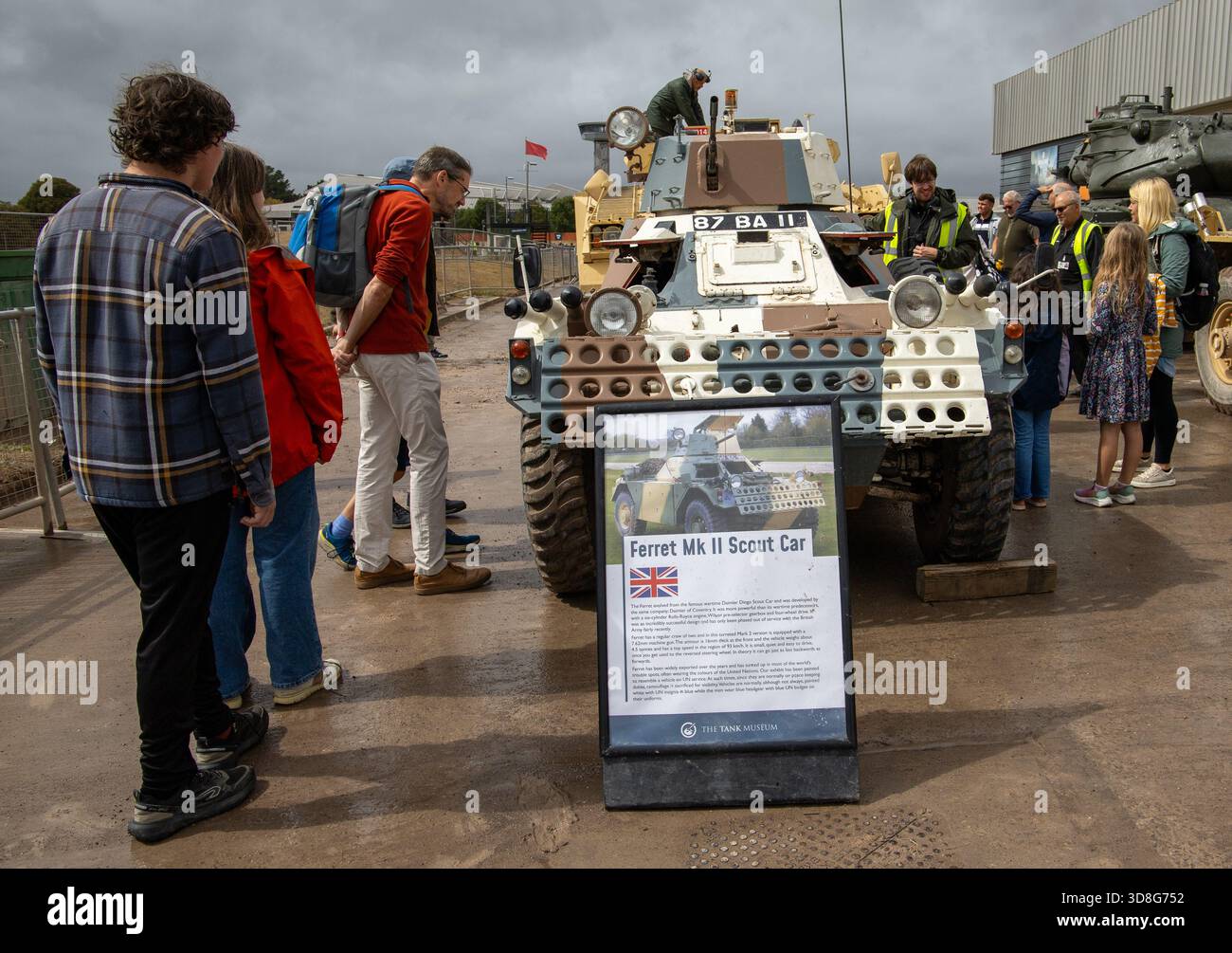Visitors observe a Ferret Mk II Scout Car display at an outdoor ...