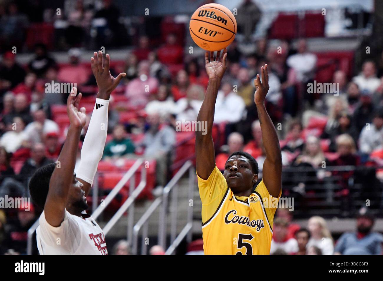 Wyoming guard Leland Walker (5) shoots the ball while Texas Tech guard ...
