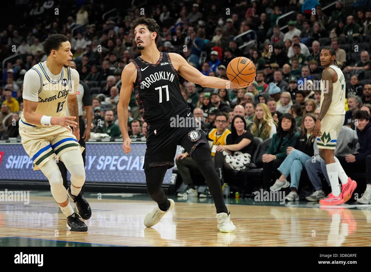 Brooklyn Nets' Ben Saraf passes against Milwaukee Bucks' Ryan Rollins ...
