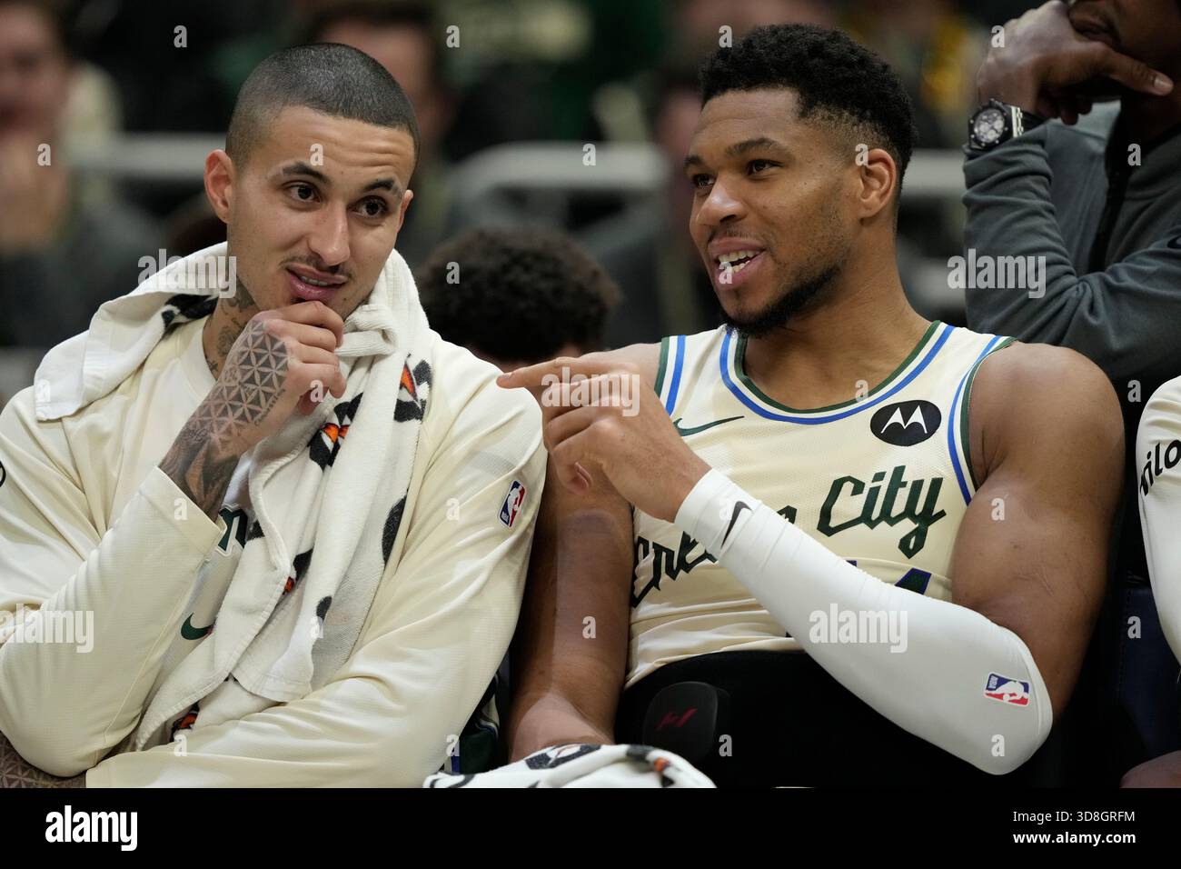 Milwaukee Bucks' Giannis Antetokounmpo talks with Kyle Kuzma on the ...