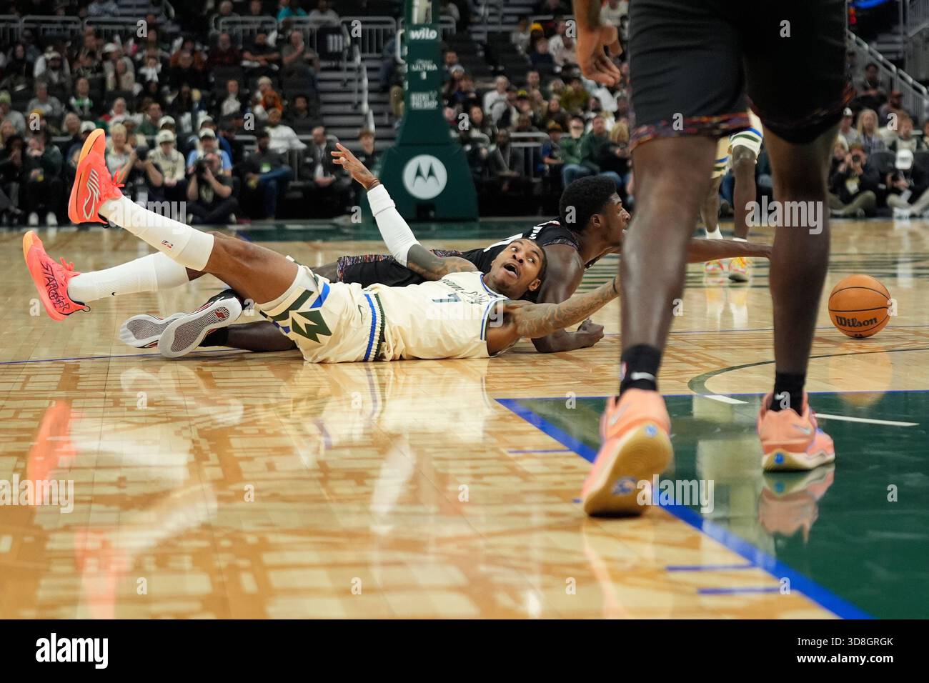 Milwaukee Bucks' Kevin Porter Jr. and Brooklyn Nets' Drake Powell dive ...